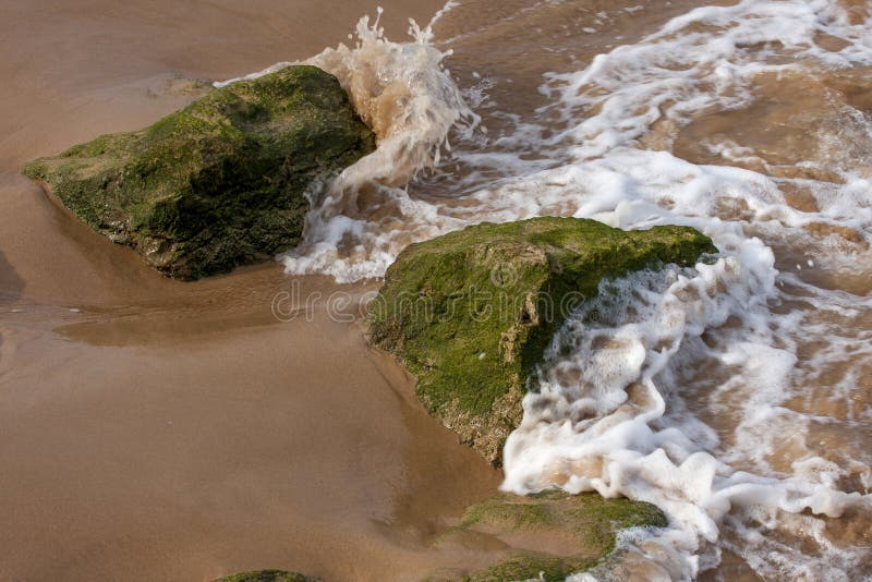 The Green Stones in the Ocean Wave Stock Photo - Image of rock, stone ...