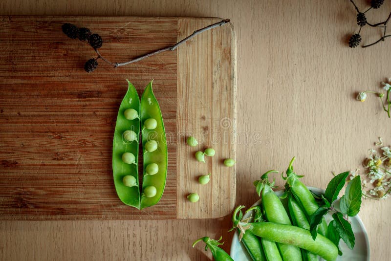 Green String of Peas on Wooden Kitchen Stock Image - Image of plate ...