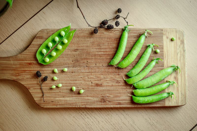 Green String of Peas on Wooden Kitchen Stock Photo - Image of chamomile ...