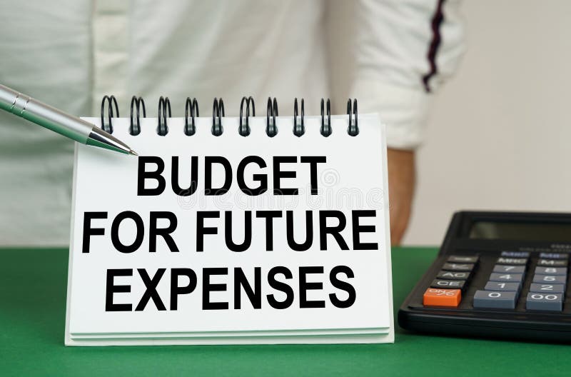 On a Green Surface, a Calculator and a Notepad with the Inscription ...