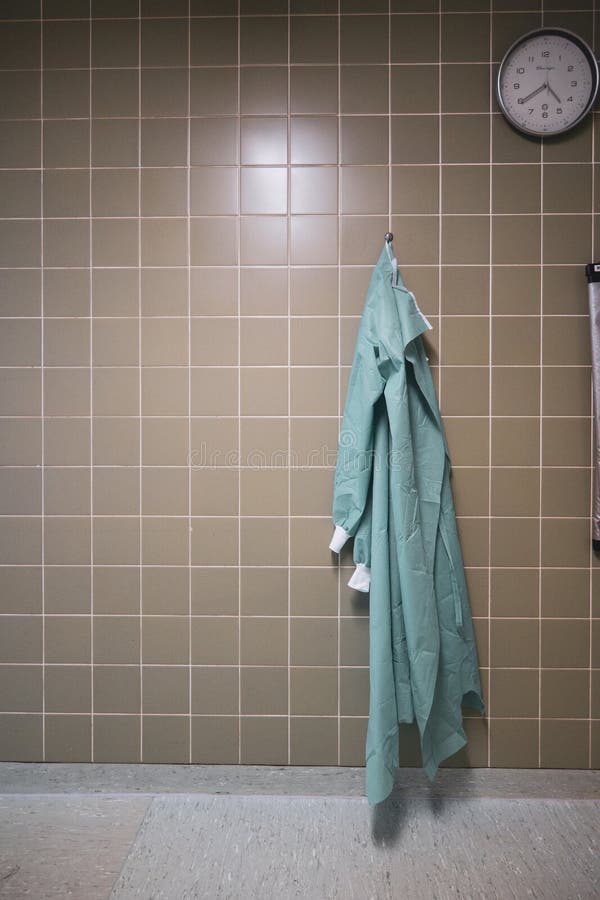 Green Surgical Gown is Hanging on a Wall in an Operating Room Stock ...