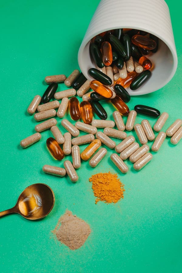 Green Tabletop with an Array of Vitamin Supplement Capsules and Pills ...