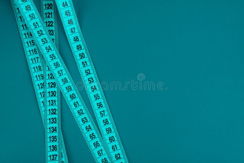 Green Tape Measure on the Bright Light Green Background Stock Photo ...