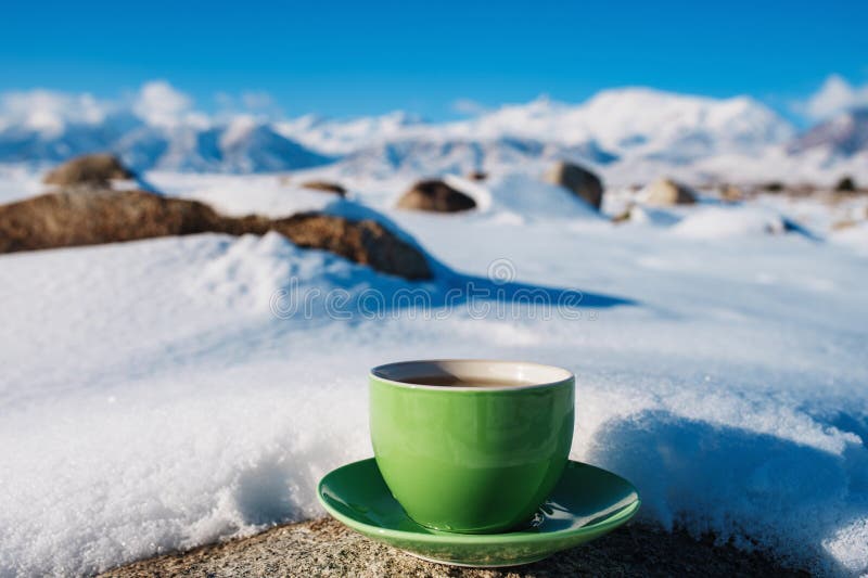 Teacup in the Snow on Mountains Background in Winter Stock Image ...