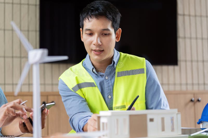 Green Tech Collaboration with Engineers Discussing Sustainable Building ...