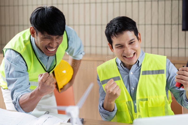 Green Tech Engineers Celebrating the Success of a Wind Energy Project ...