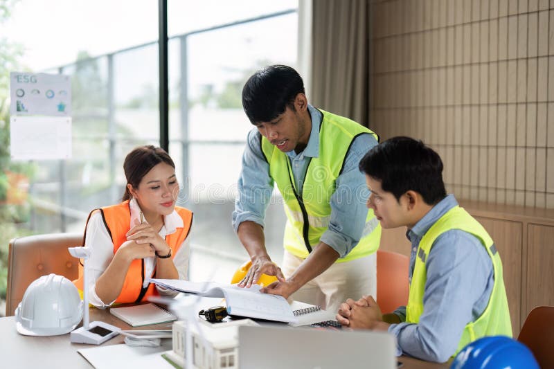 Green Tech Strategy Meeting. Engineers Collaborating on Sustainable ...