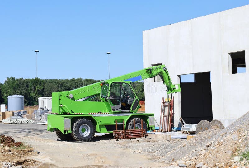 Green Telescopic Handler at Work during the Construction of Concrete ...