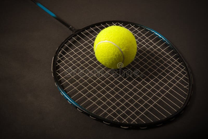 Tennis Ball And Racket On Dark Stock Photo - Image of recreation, green ...