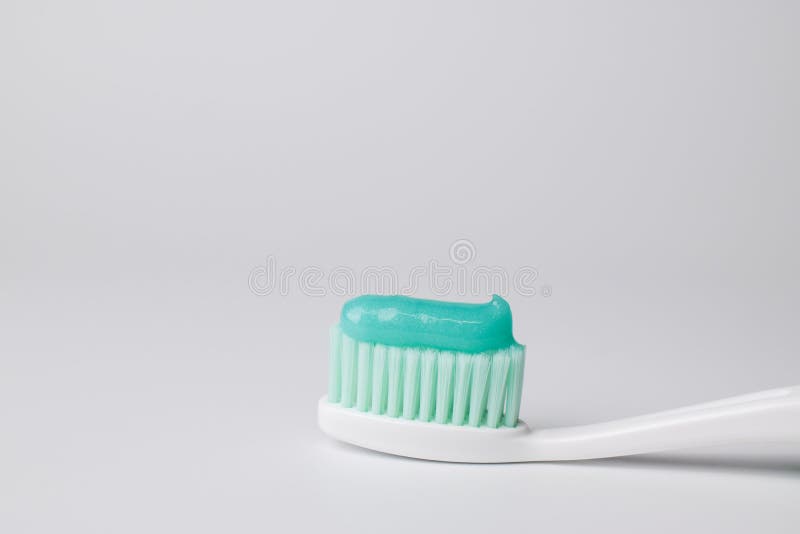 Green Toothpaste on a Toothbrush on White Background Stock Photo ...
