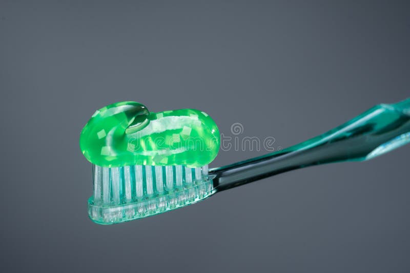 Green Toothpaste. Toothpaste on a Toothbrush. Toothpaste with Additives ...