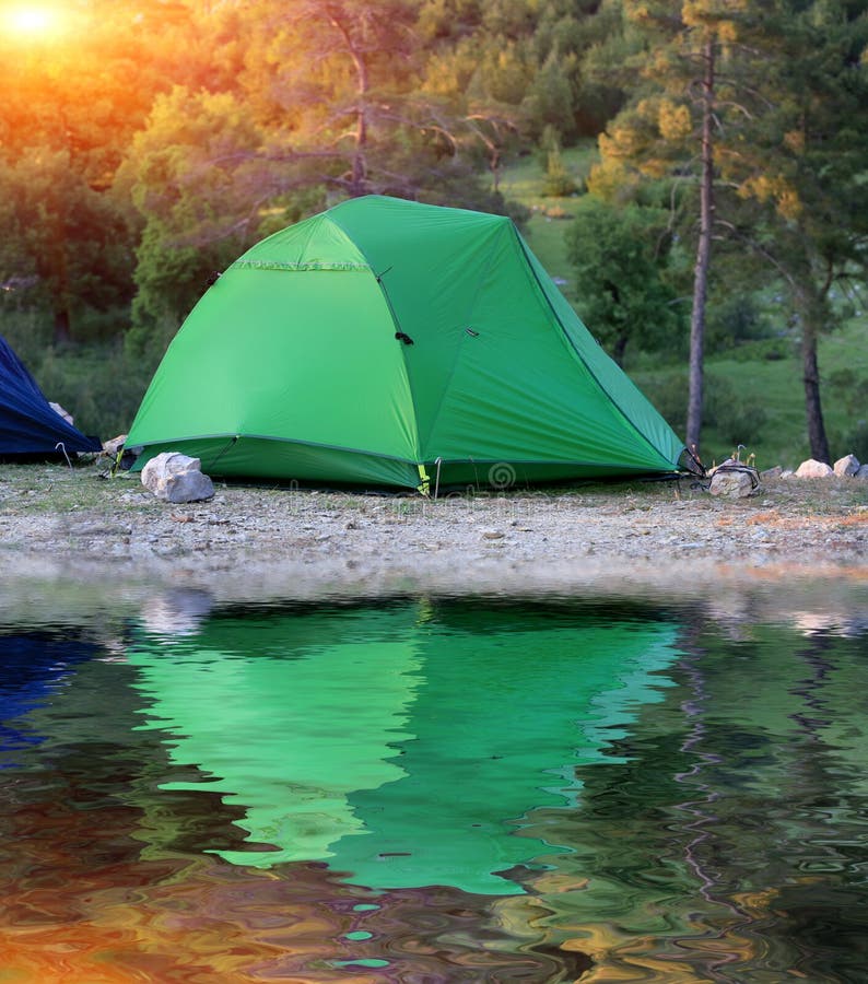 Green Tent Outdoors In The Mountains By Lake During Sunset Hours ...