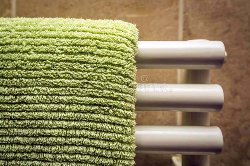 Green towel on radiator stock photo. Image of luxury - 29923164
