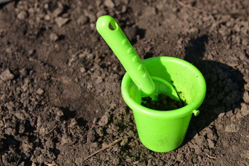 Green Toy Bucket and Spade in Mud Stock Image - Image of shovel ...