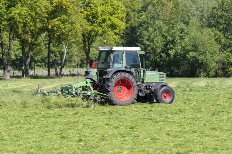 Pasture Mowing with Blue Tractor Stock Photo - Image of farmer ...