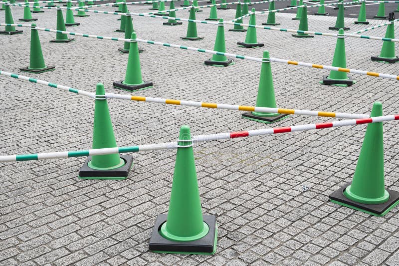 Green Traffic Cones with Barricades Forming a Queuing System Stock ...