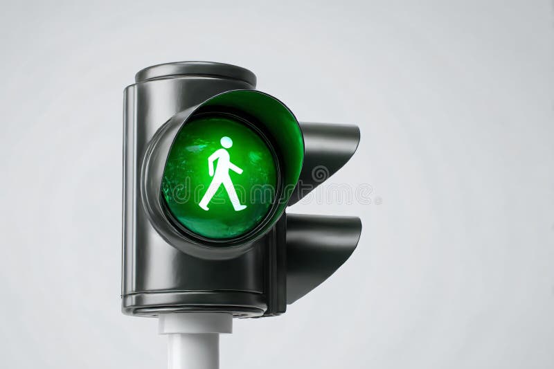 A Green Traffic Light with a Walking Person Symbol on it Stock ...