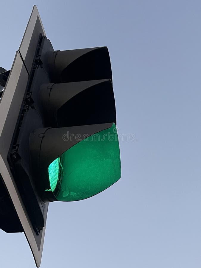 Traffic Lights Glowing Green Against Evening Sky Stock Photo - Image of ...