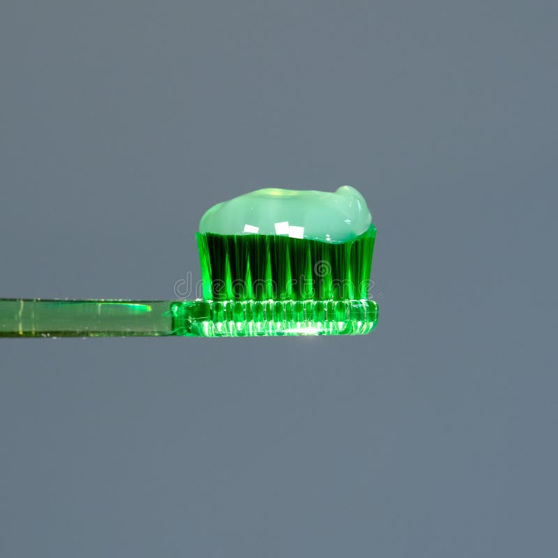 Green Transparent Toothpaste on Green Toothbrush on Black Background ...