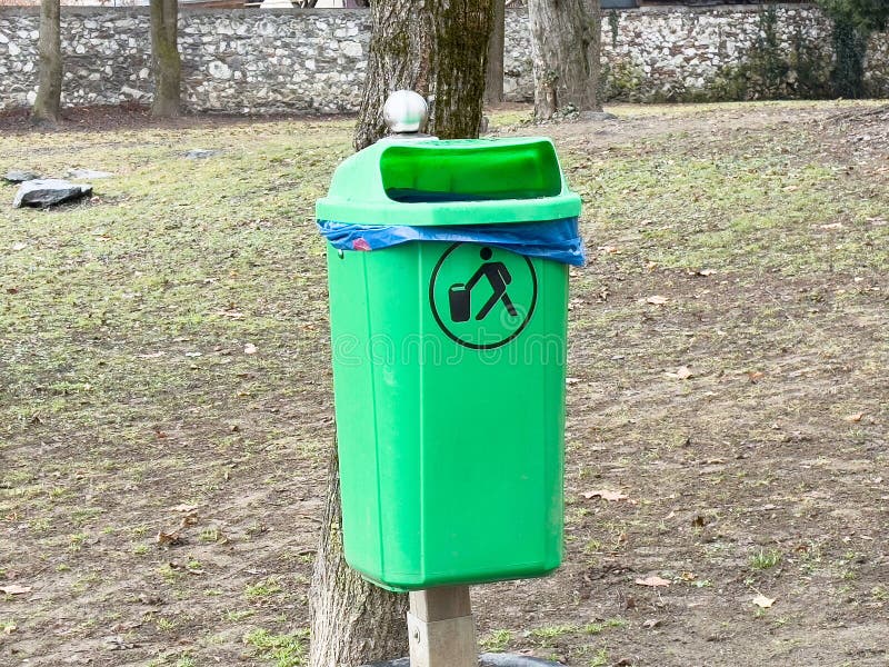 Green Trash Bin in Park with Litter Symbol Stock Photo - Image of ...