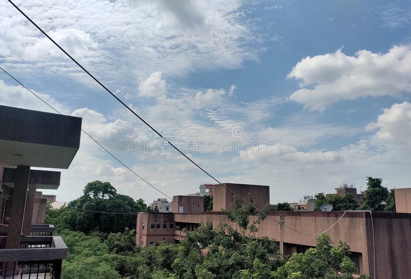 Green Trees between the Buildings in White Clouds Stock Image - Image ...