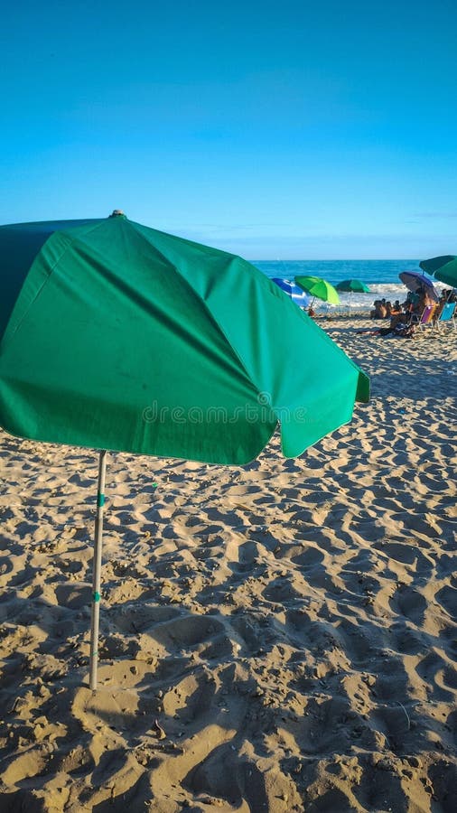 Green Umbrella on the Beach on a Sunny Day Stock Image - Image of ...