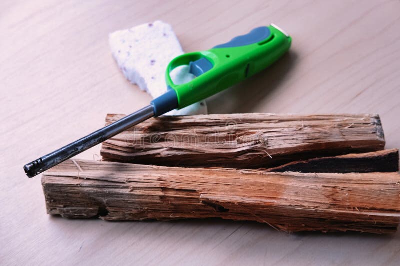 Green Utility Lighter and Firelighter Brick on Wooden Surface Stock ...
