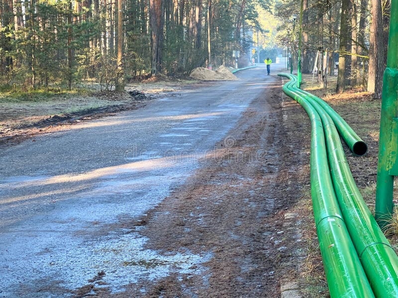 Green, Welded Sewage Pipes Lying on the Side of the Road Under Which ...