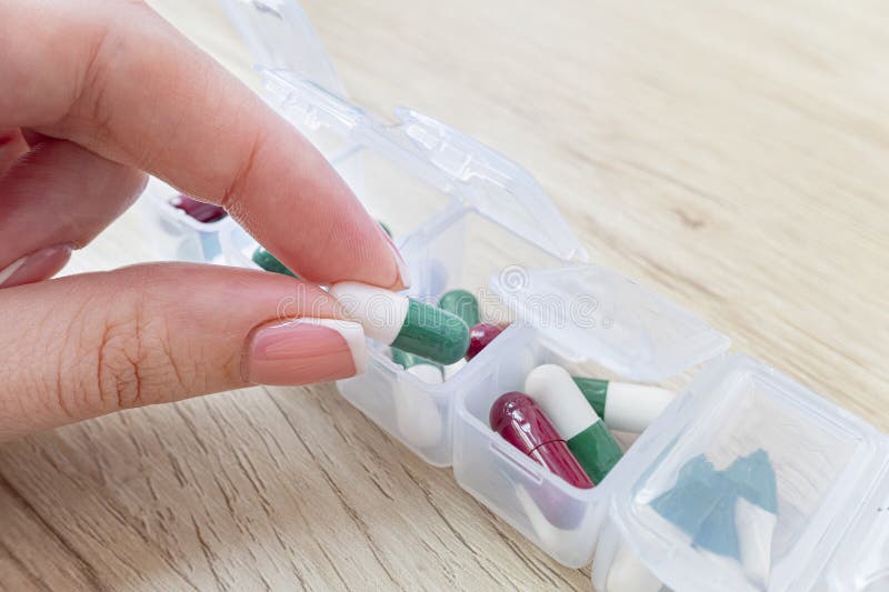 A Green and White Capsule in the Woman S Hand. Pill Container. Stock ...