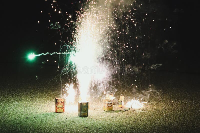 Green and White Dot Spray Fireworks on Cement Stock Photo - Image of ...