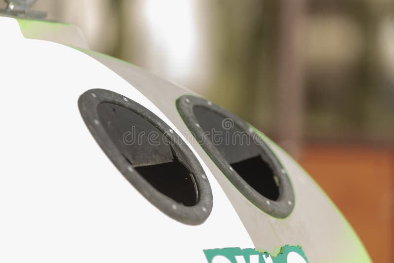 A Green and White Recycling Bin Featuring Two Distinct Holes in it ...
