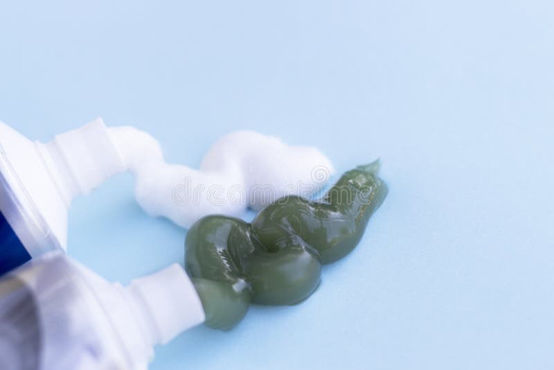 Green and White Toothpaste Squeezed Out of Tubes on Blue Background ...