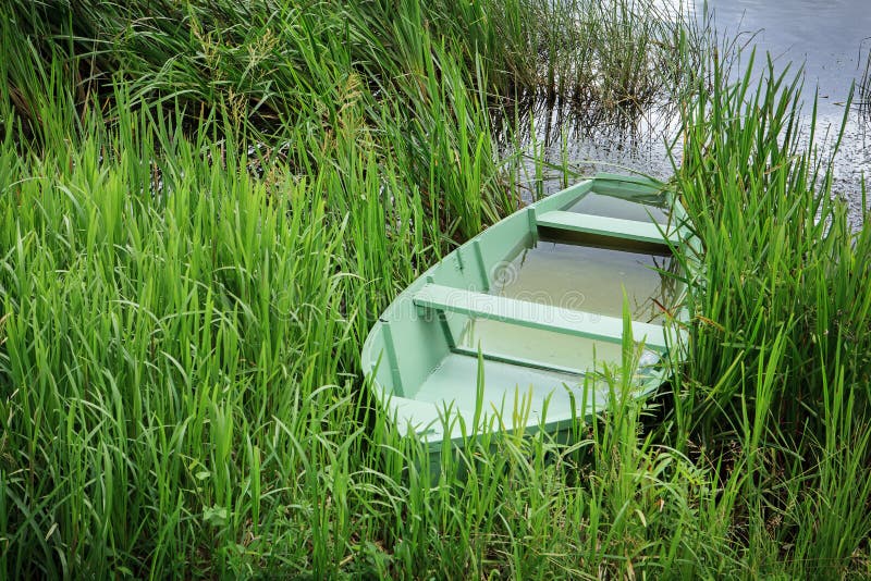 Green wooden rowing boat stock photo. Image of grass - 75890916