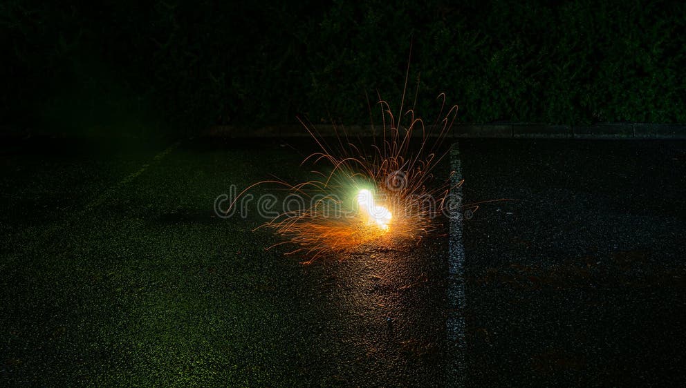 Green and Yellow Ground Fireworks on Asphalt.. Stock Photo - Image of ...