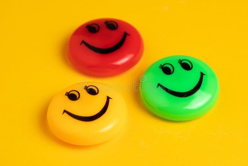 Green Yellow and Red Round Magnet with Smile in a Row on a Yellow ...