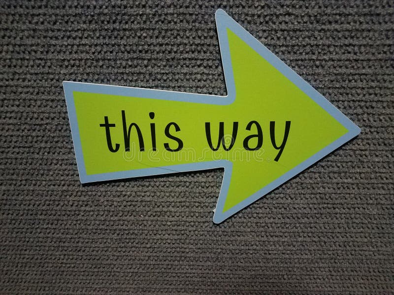 Green or Yellow this Way Sign on Grey Wall Stock Image - Image of sign ...