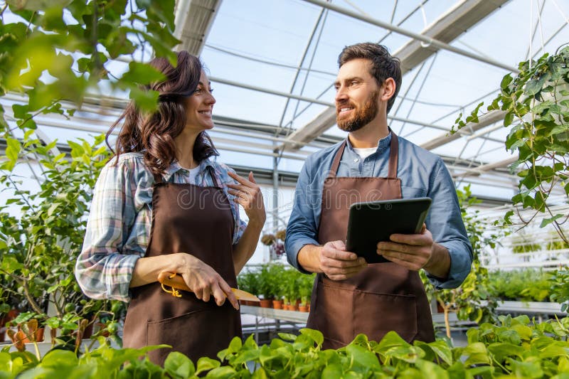 Greenhouse Worker Talking To a Supervisor and Looking Involved Stock ...