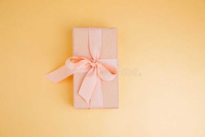 Greeting Background. Gift Wrapping in Soft Pink Paper on a Yellow ...