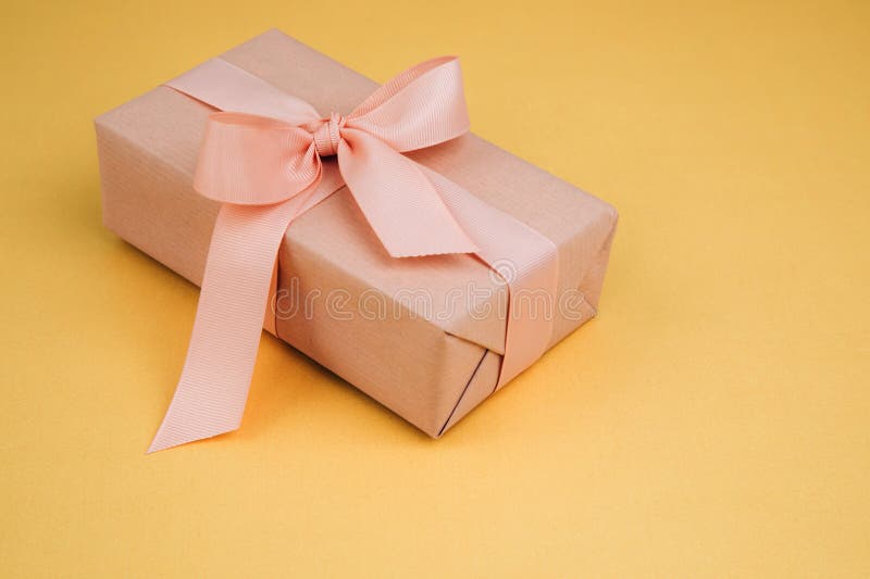 Greeting Background. Gift Wrapping in Soft Pink Paper on a Yellow ...