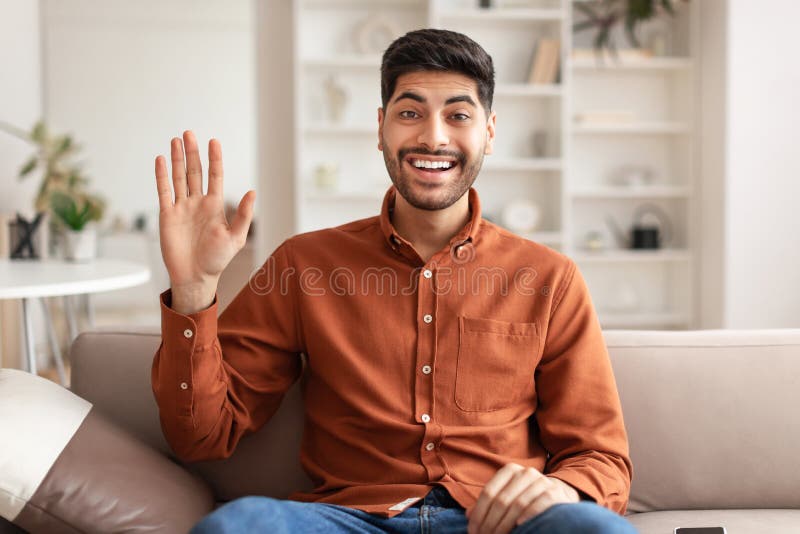 Greeting Concept. Friendly Black Man Waving at Camera and Smiling ... Greeting Concept. Friendly Black Man Waving at Camera and Smiling ...