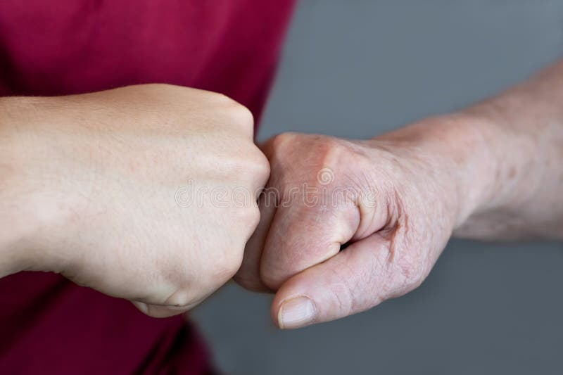 Greeting a Young and Old Person with a Fist Bump Gesture, Connection ...