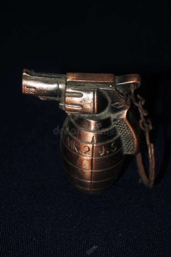 Grenade and Gun Shaped Keychains Stock Photo - Image of iron, sculpture ...