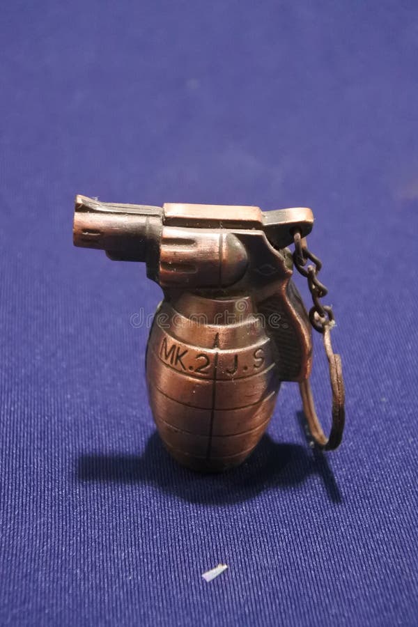 Grenade and Gun Shaped Keychains Stock Photo - Image of ceramic ...