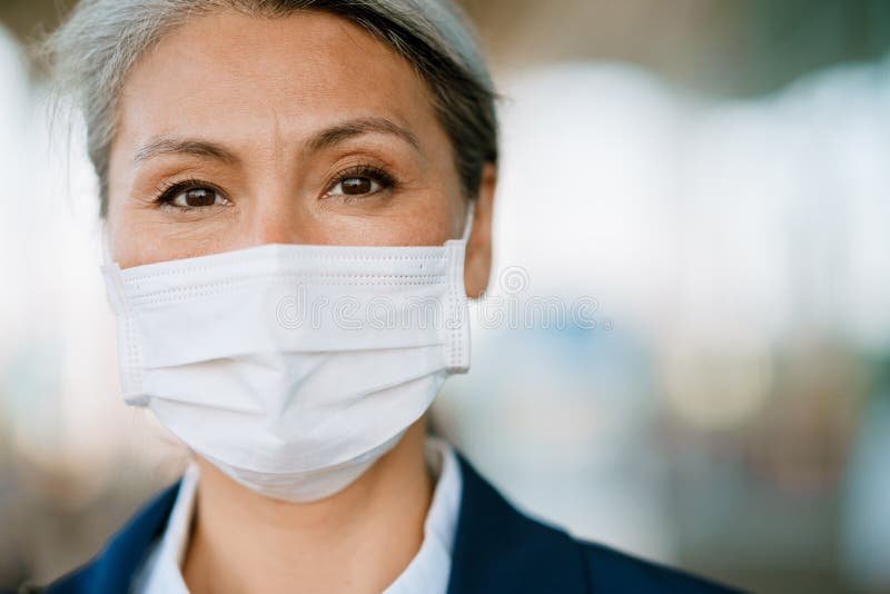 Grey Asian Woman Looking at Camera while Posing in Face Mask Stock ...
