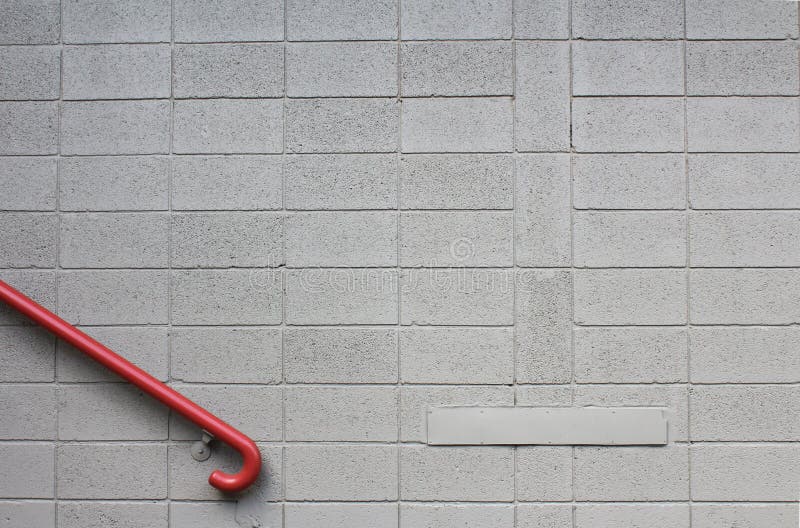 Grey Cinder Block Wall with Red Hand Rail Stock Photo - Image of shadow ...