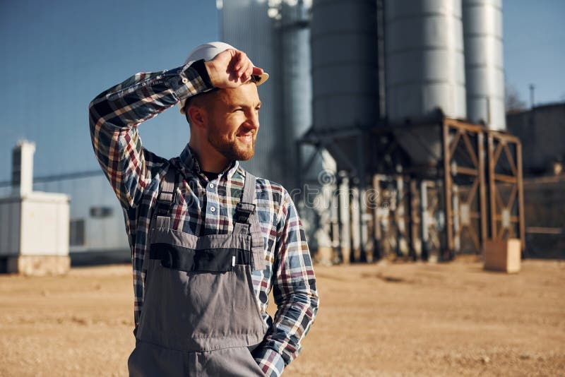 In Grey Clothes. Construction Worker in Uniform is Outdoors Near the ...