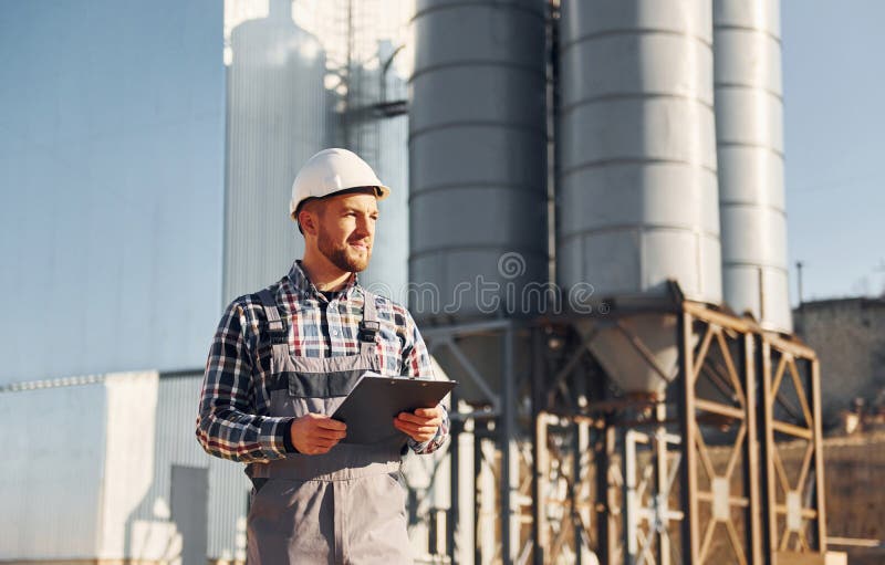 In Grey Clothes. Construction Worker in Uniform is Outdoors Near the ...