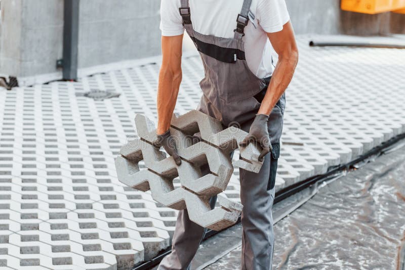 Grey Colored Clothes. Young Man Working in Uniform at Construction at ...