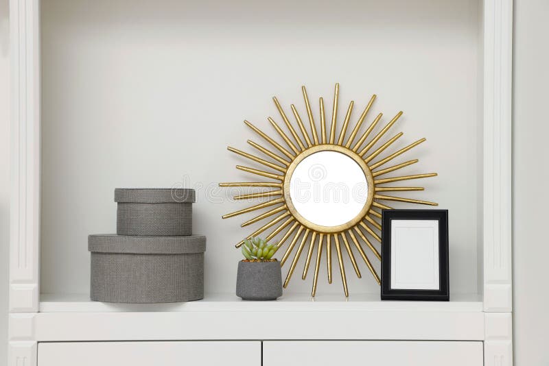 Grey Decorative Boxes, Houseplant, Mirror and Frame on Shelving Unit ...