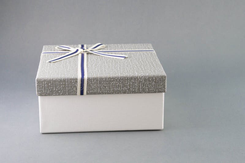 Grey Gift Box with Ribbon on Green Grass with Sun Light in the Morning ...